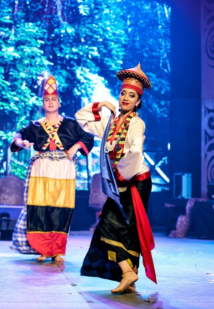 Dancers performing a cultural dance in traditional costume at Kampung ...
