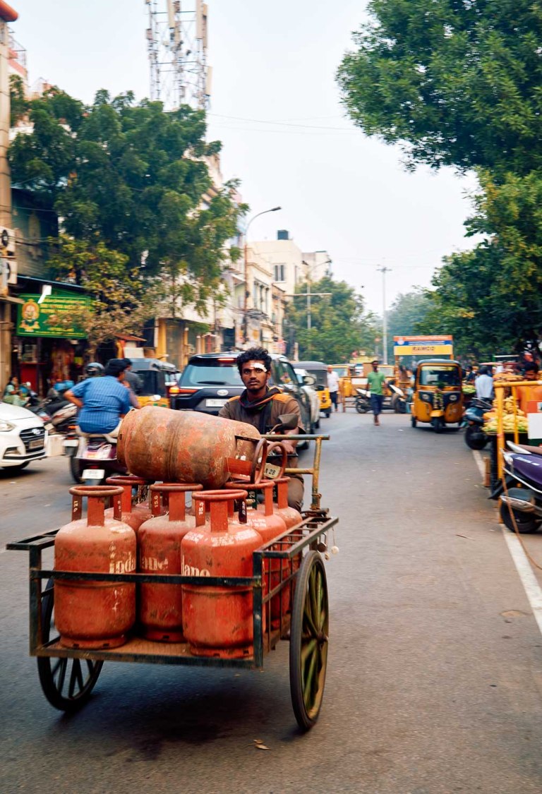A gas cylinder delivery man in his tricycle at Mylapore, Chennai, Tamil ...